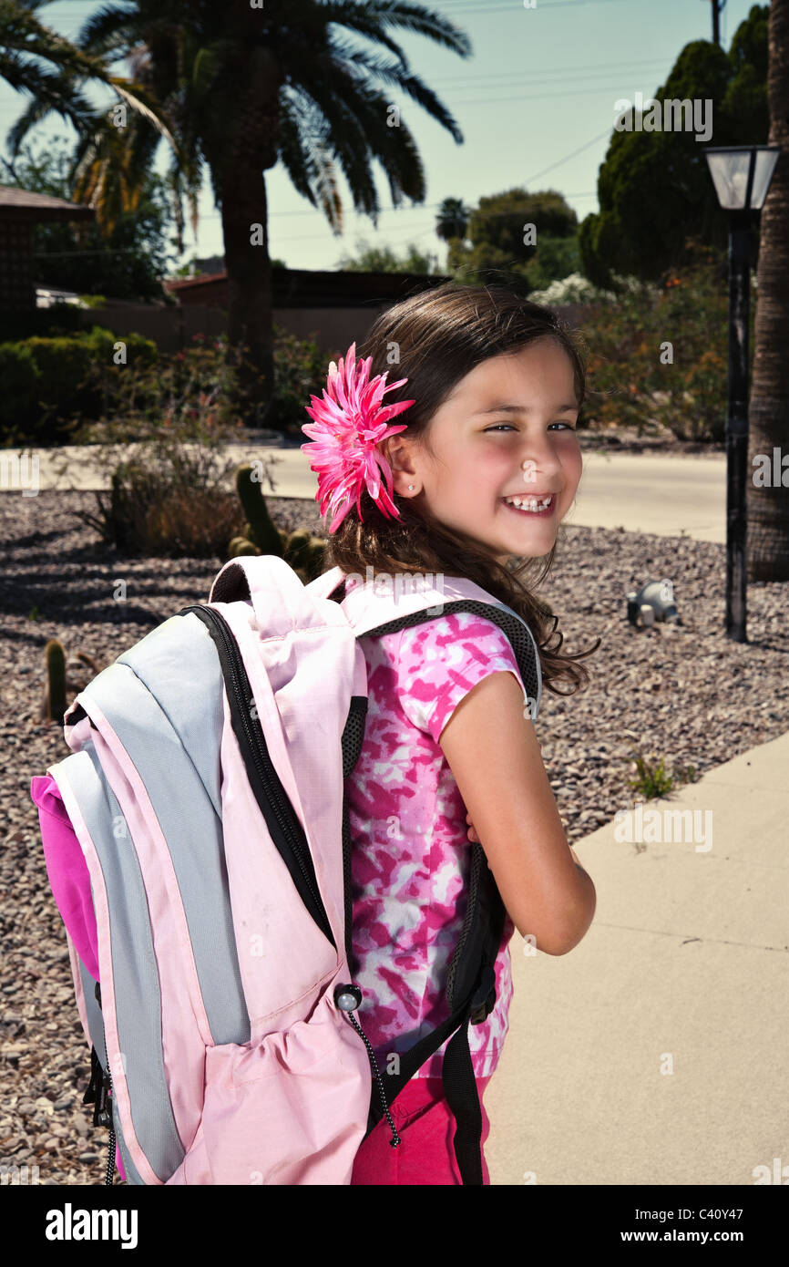 young girl with her pink backpack smiling Stock Photo - Alamy