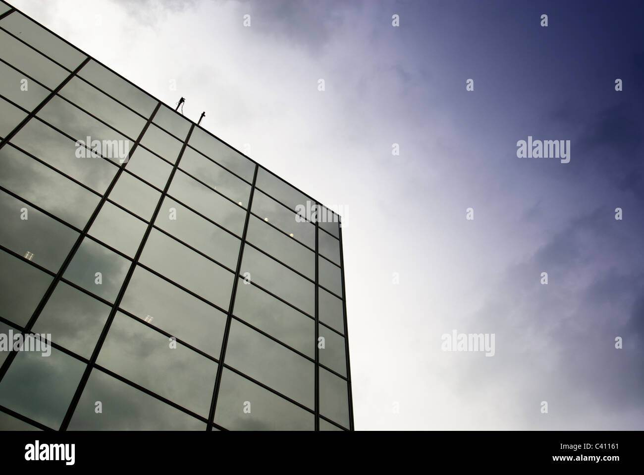 glass office building with stormy sky Stock Photo - Alamy
