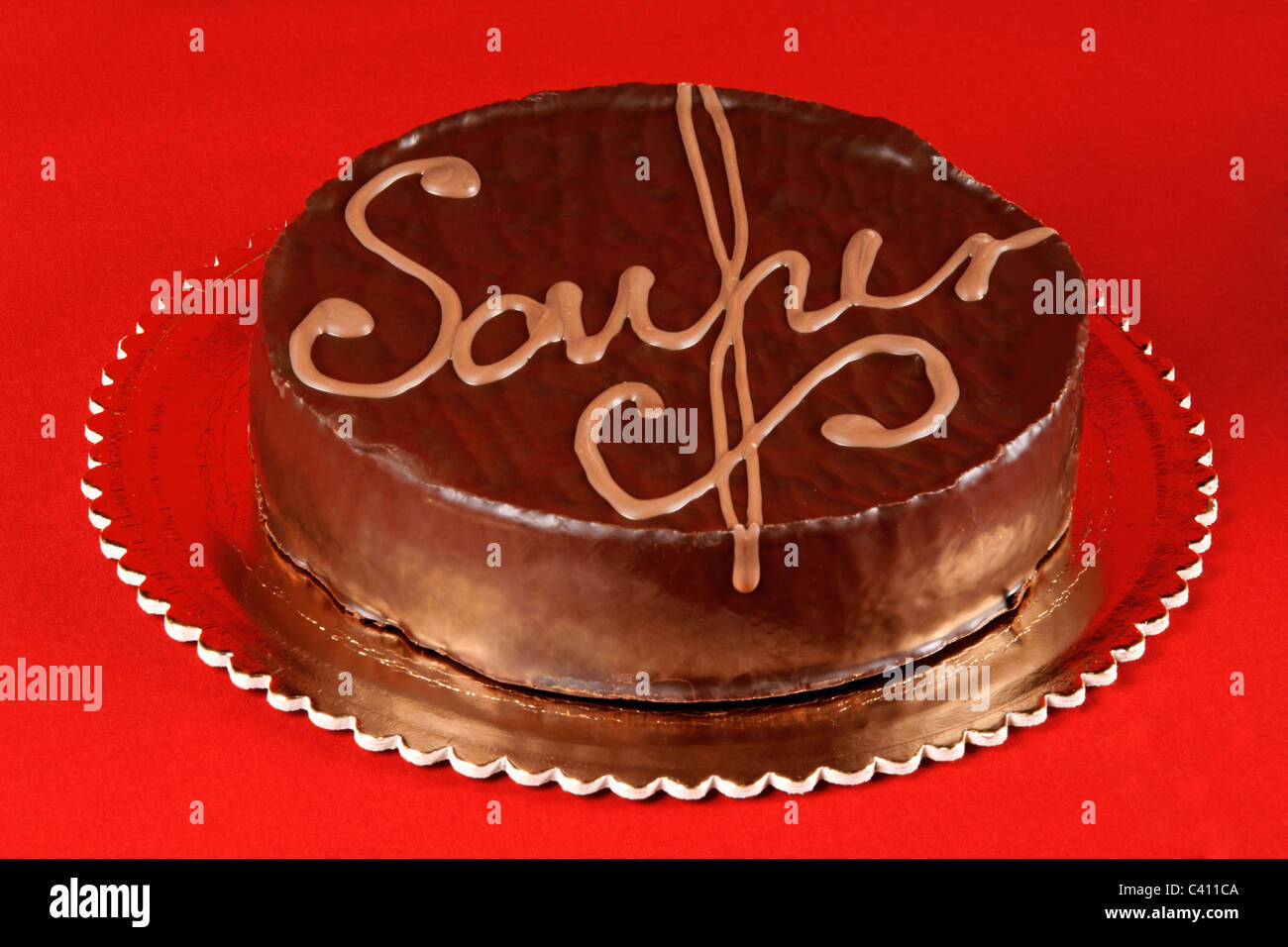 Famous austrian chocolate cake called sacher torte served on a golden ...