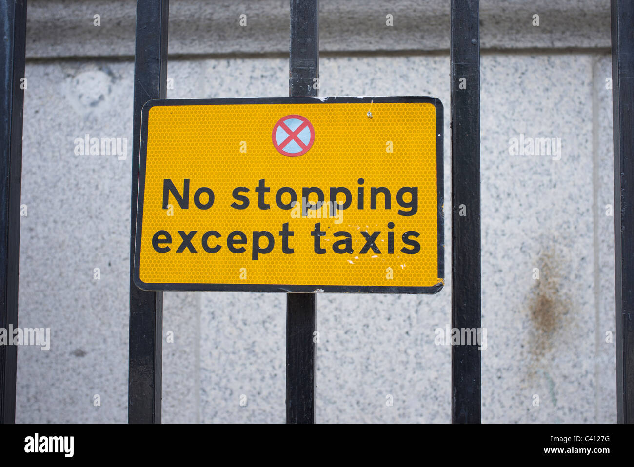 no stopping sign except for taxis on railing in the UK Stock Photo - Alamy