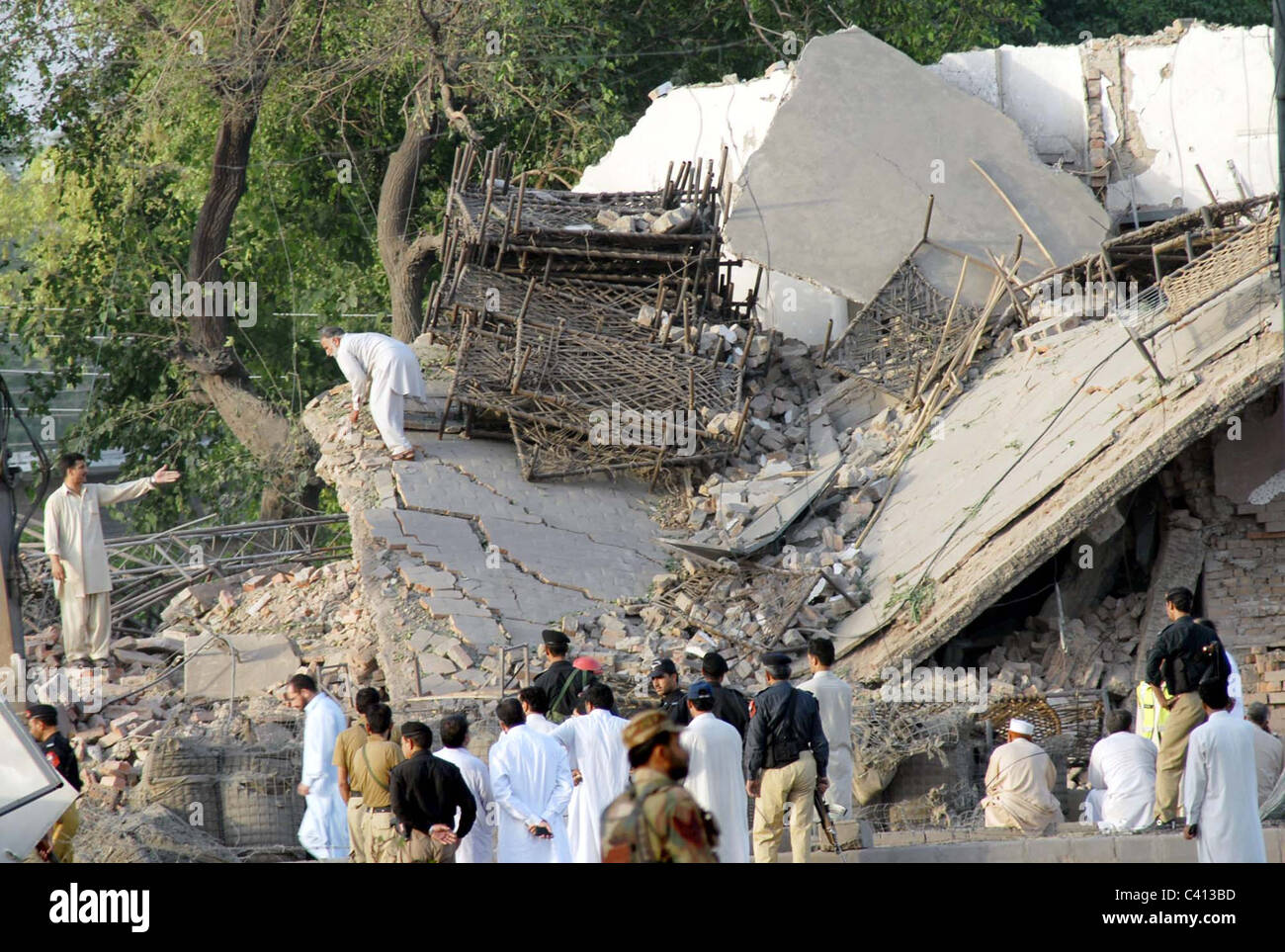 Security official gather at the site of explosion during rescue ...