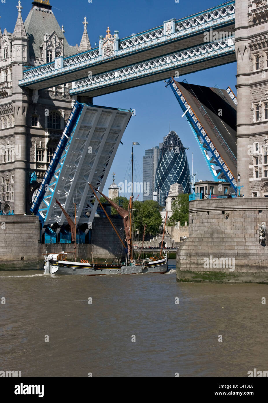 Sailing boat passing under grade 1 listed open Tower Bridge with the ...
