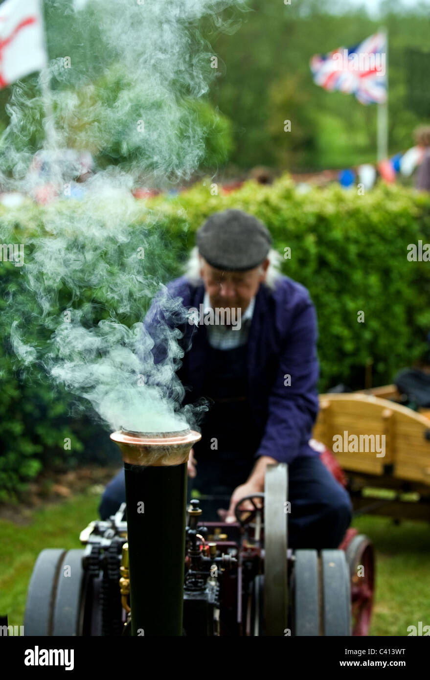 A man driving a miniature steam traction engine at a steam fair Stock ...