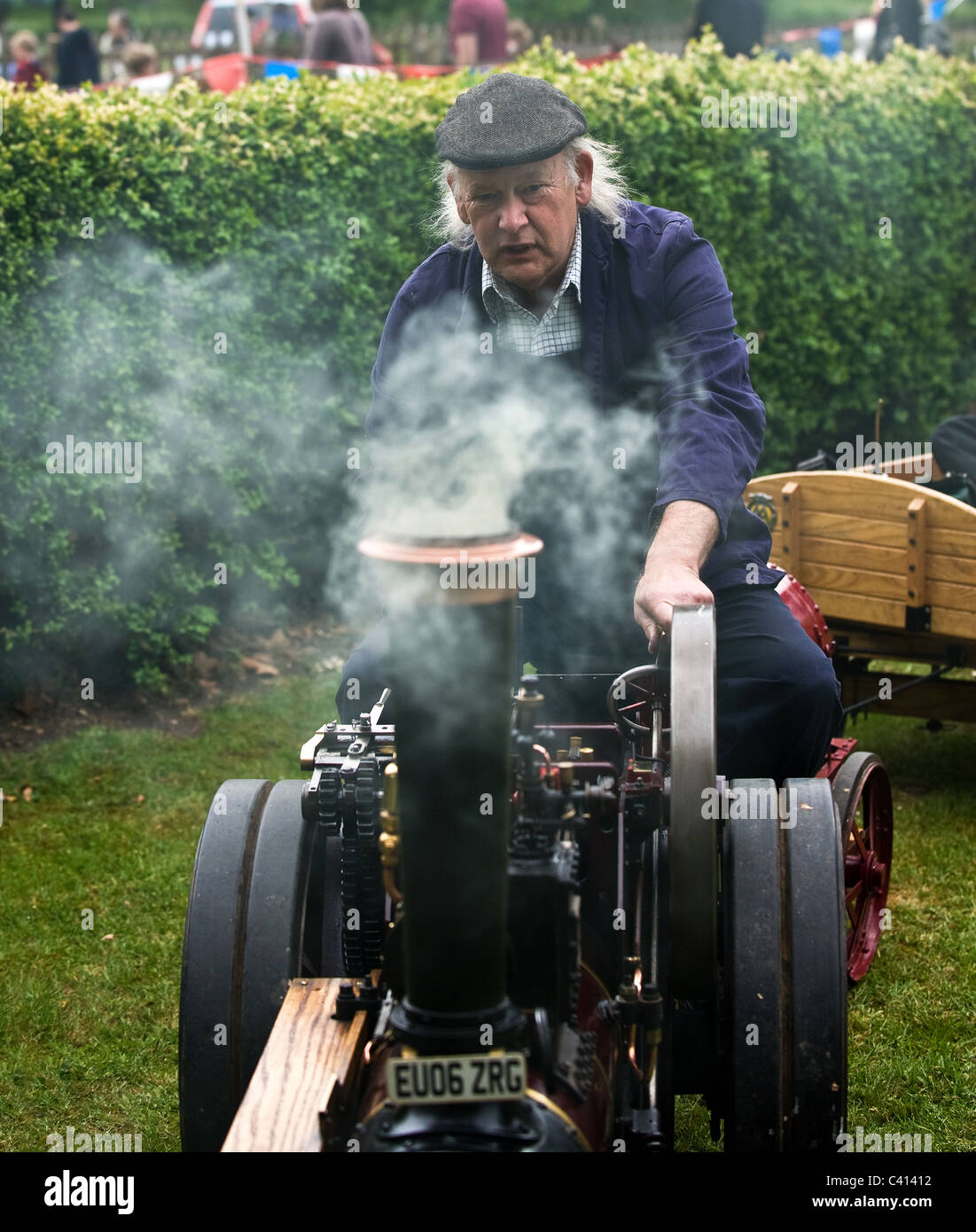 A man driving a miniature steam traction engine at a steam fair Stock ...
