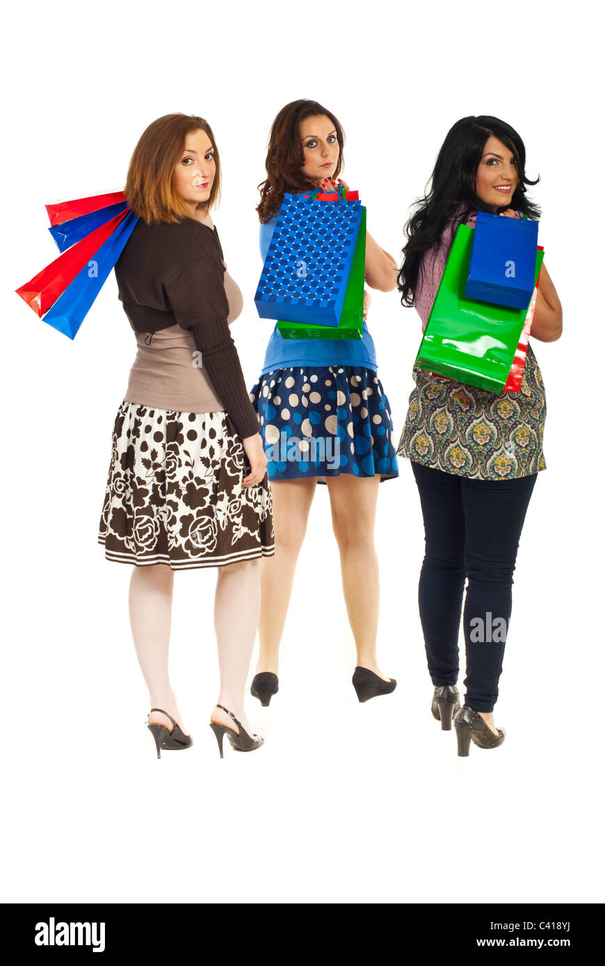 Three women walking holding shopping bags on their shoulders and ...