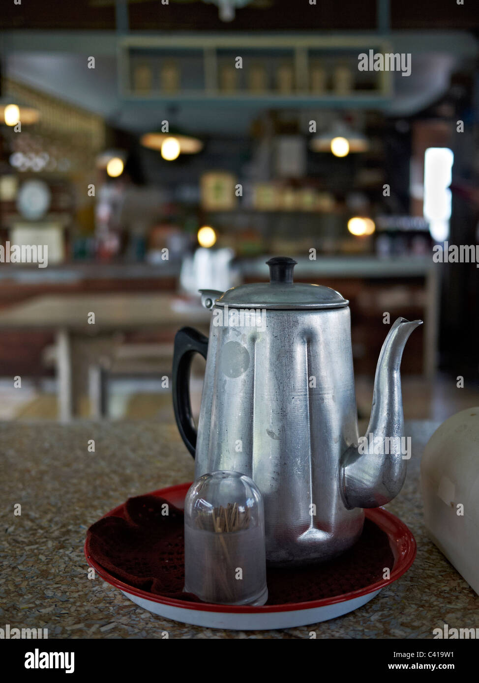 Old metal teapot used as a water jug Stock Photo - Alamy