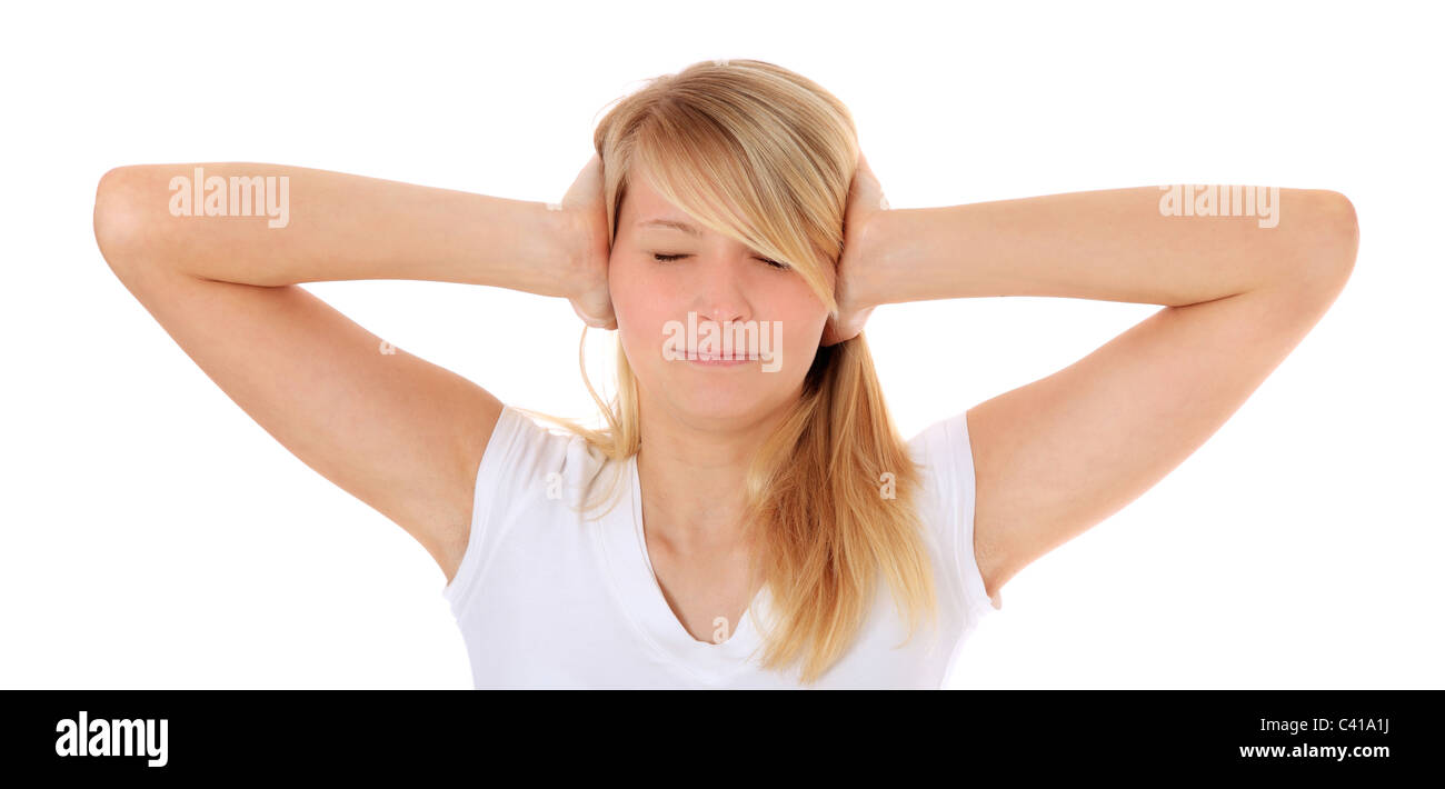 Attractive teenage girl keeps her ears shut. All on white background ...