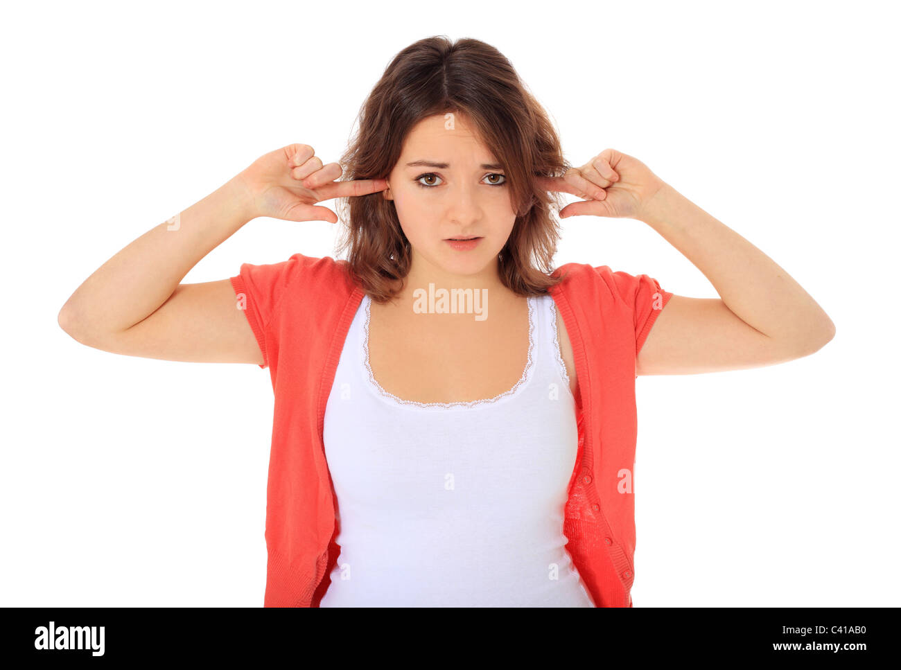Attractive young woman keeps her ears shut. All on white background ...