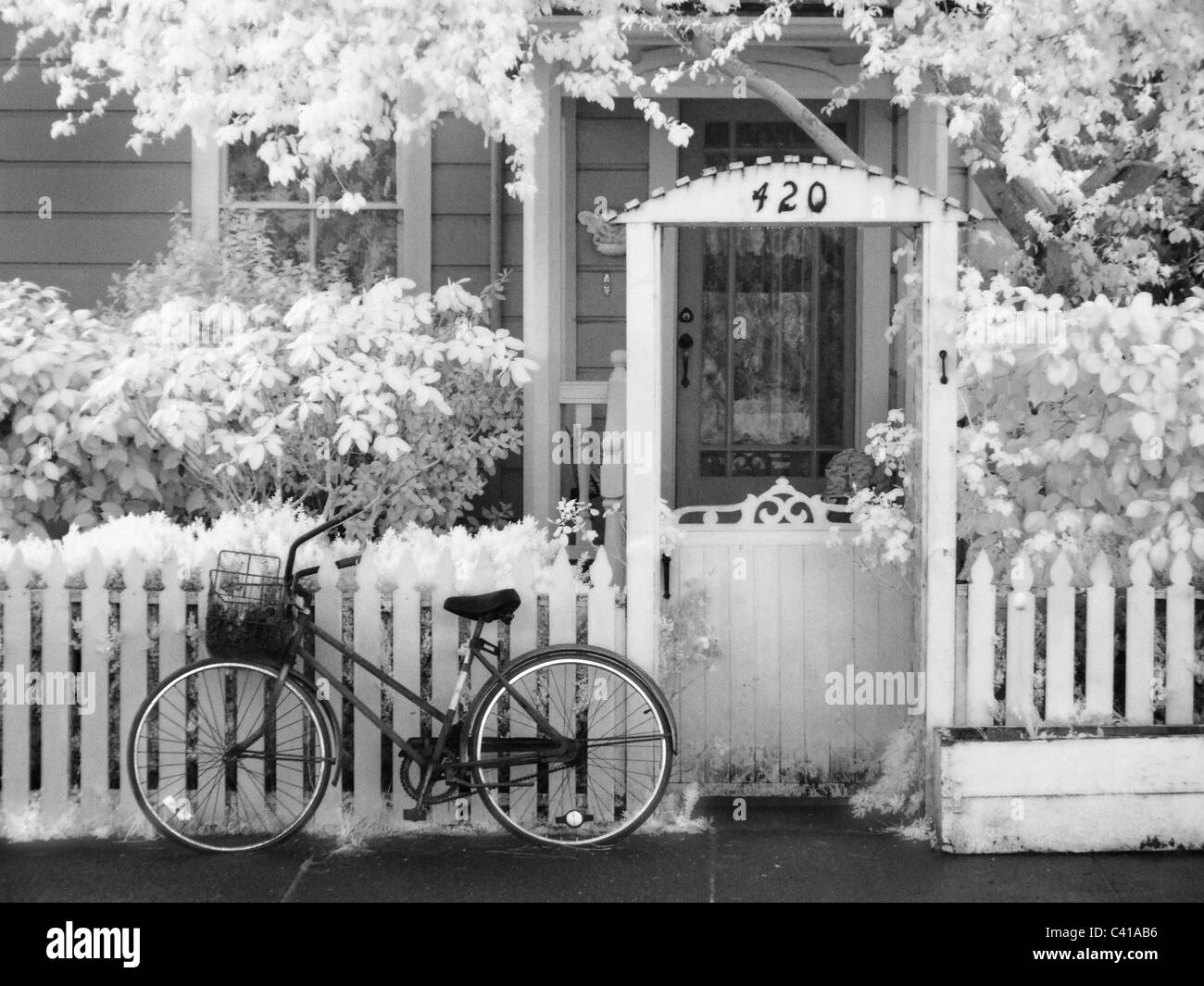 Bicycle parked on sidewalk Stock Photo - Alamy