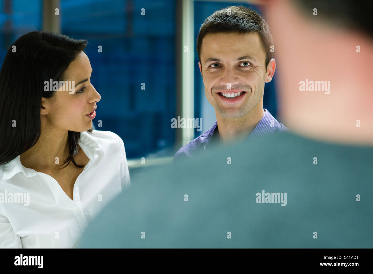 Colleagues talking in office Stock Photo - Alamy