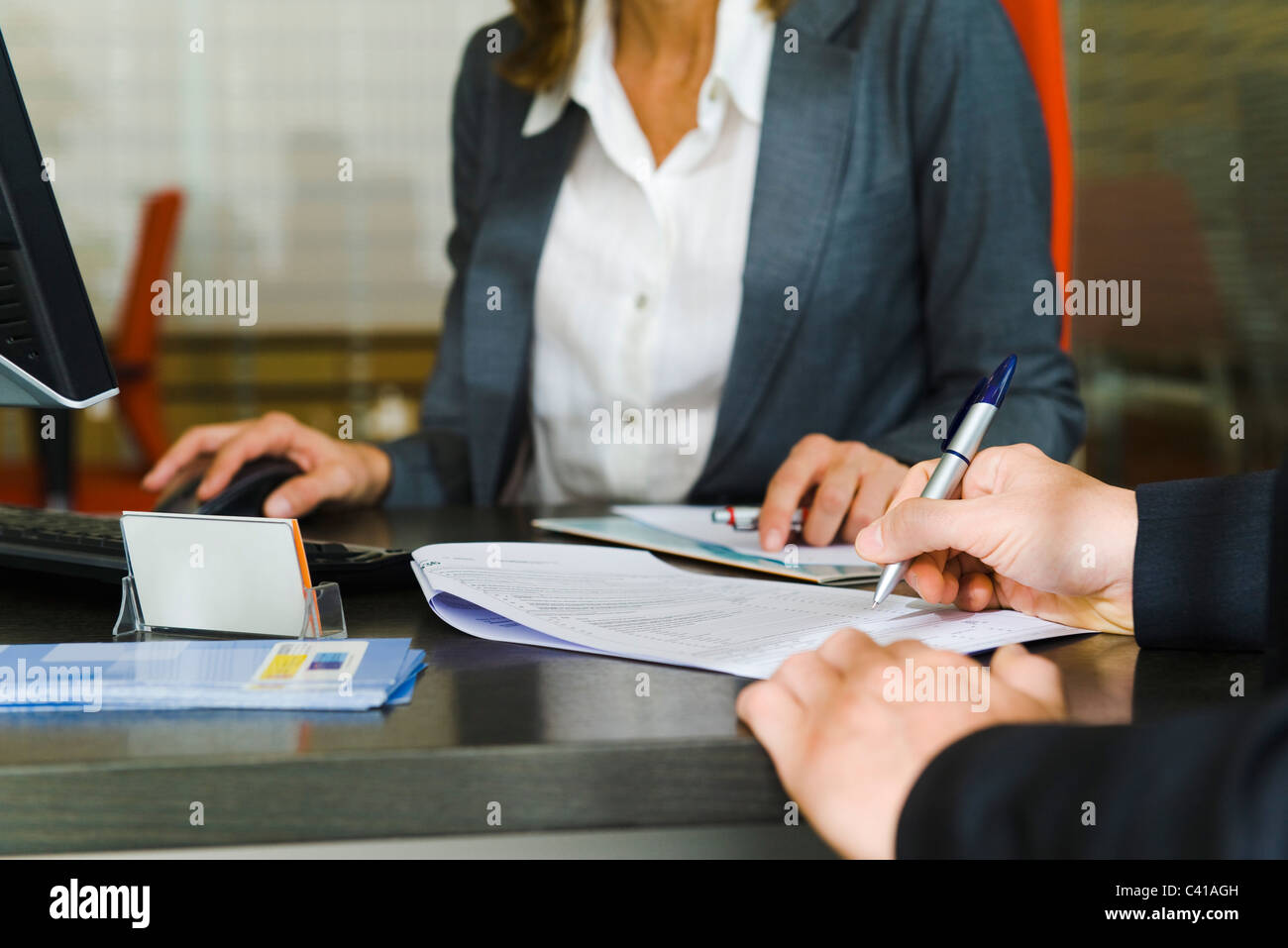 Person signing paperwork, mid section Stock Photo - Alamy
