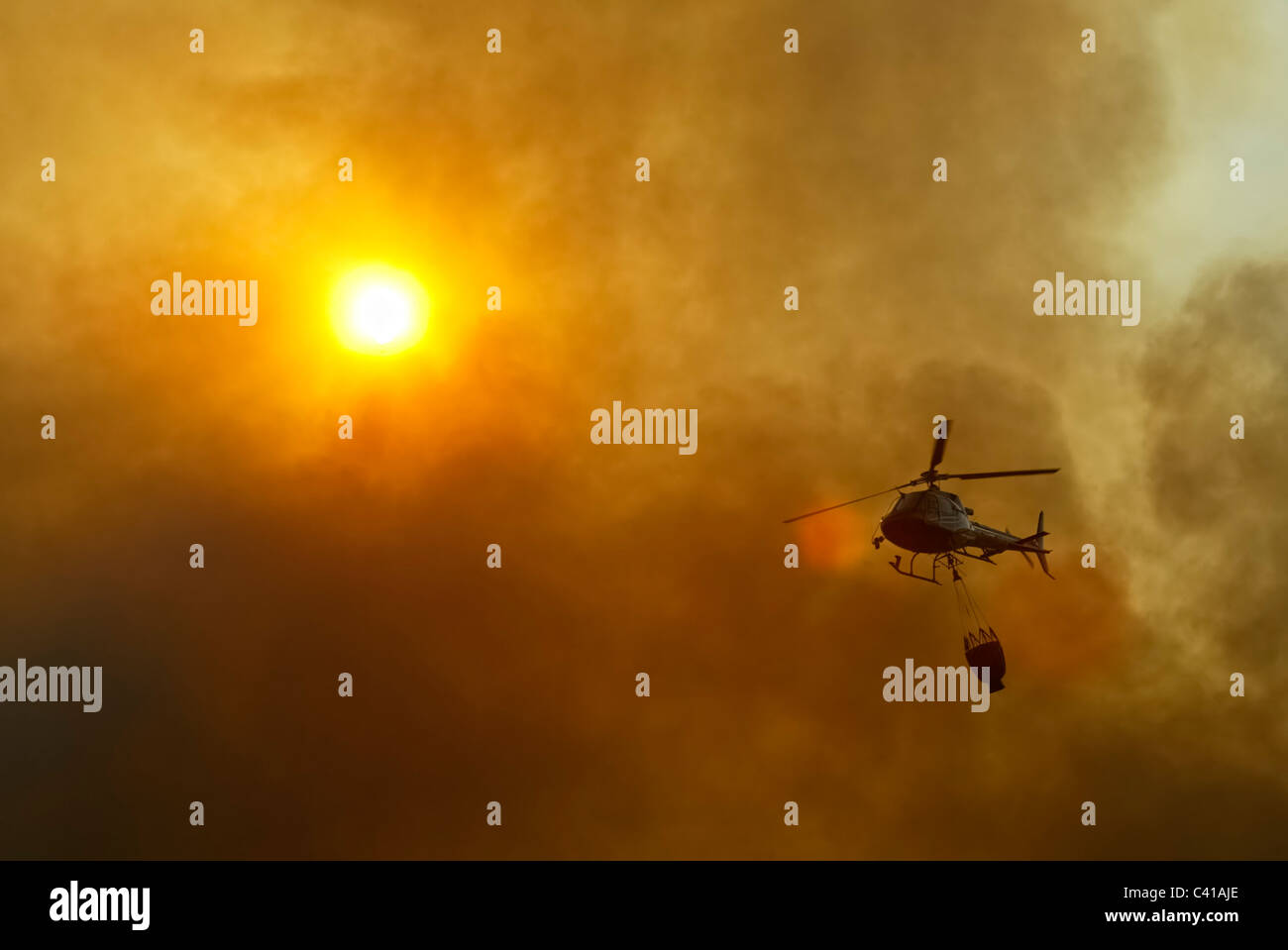 Fire department helicopter prepares to drop water on a wildfire Stock ...