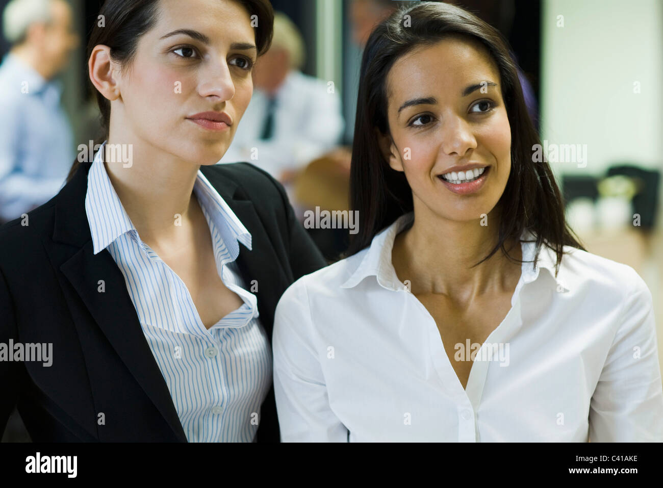 Female colleagues talking in office, portrait Stock Photo - Alamy