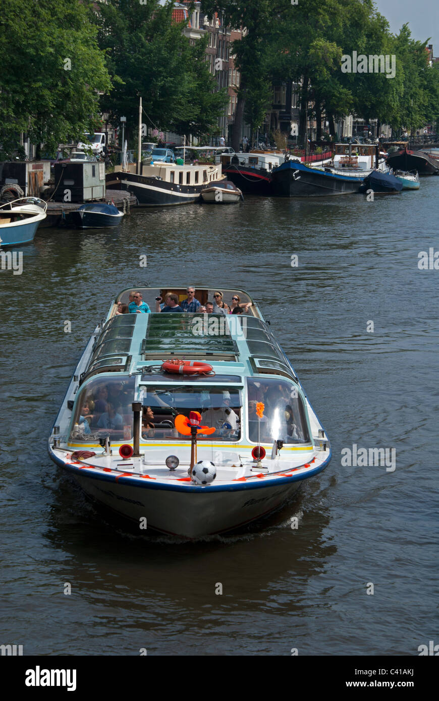 A tour boat on a canal in Amsterdam, Netherlands Stock Photo - Alamy