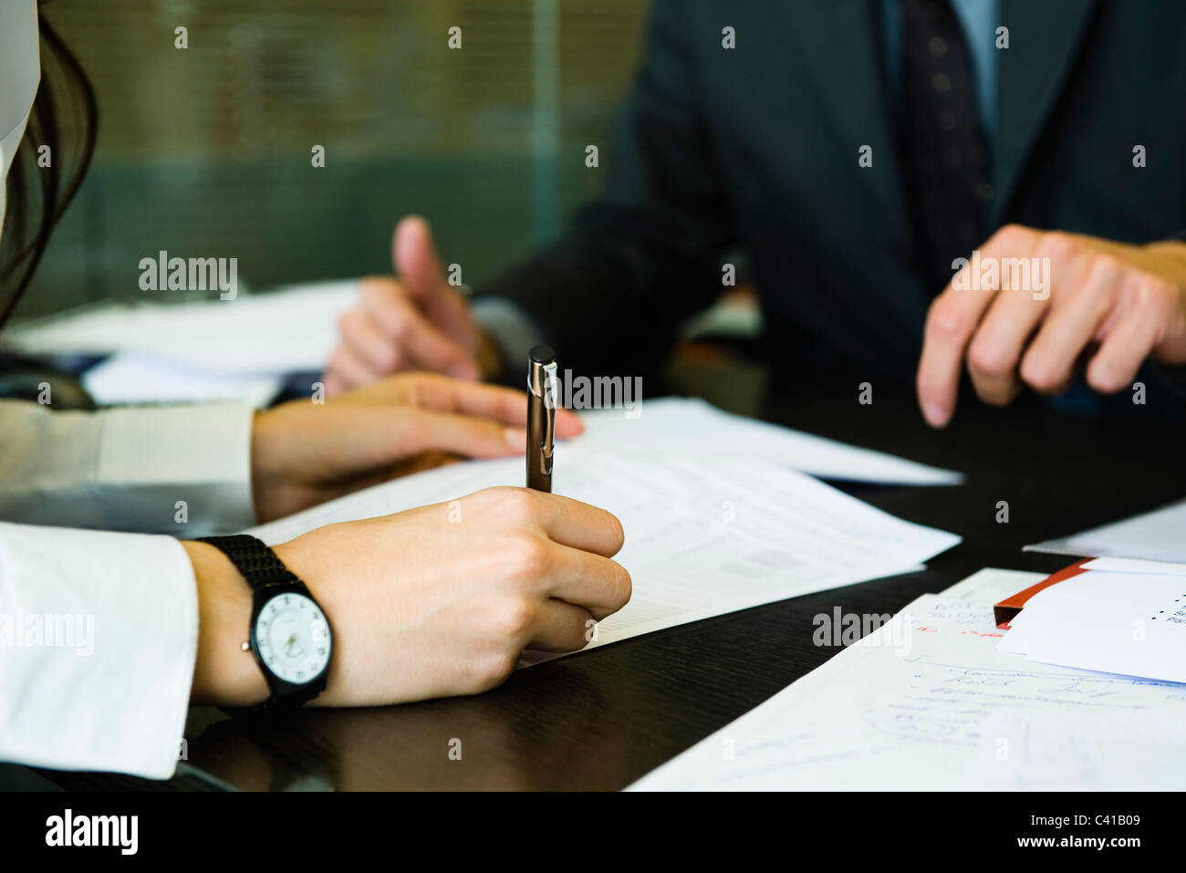 Two businessmen doing paperwork at desk in the office Stock Photo - Alamy