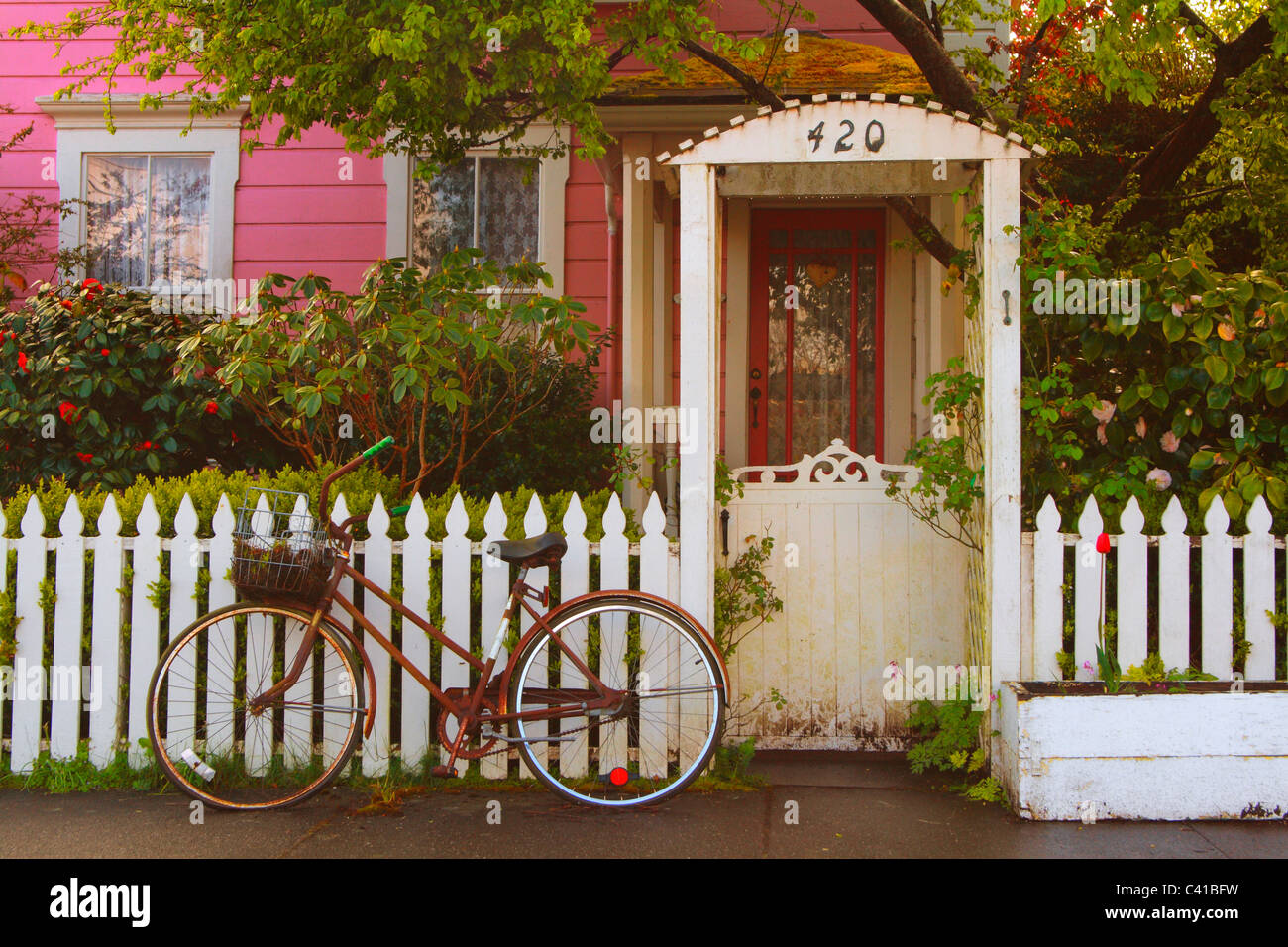 Bicycle parked on sidewalk Stock Photo - Alamy