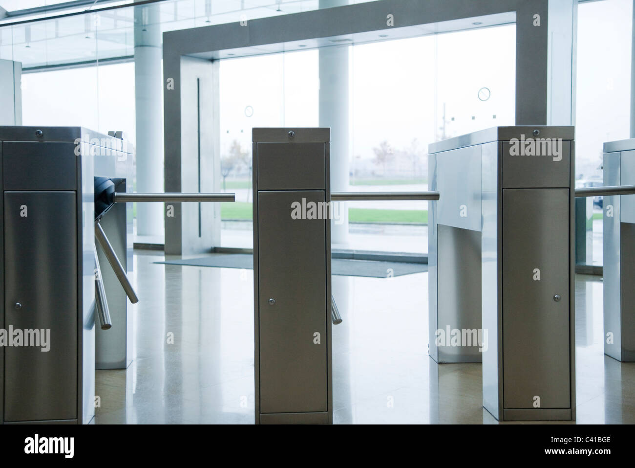Turnstiles in building lobby Stock Photo - Alamy