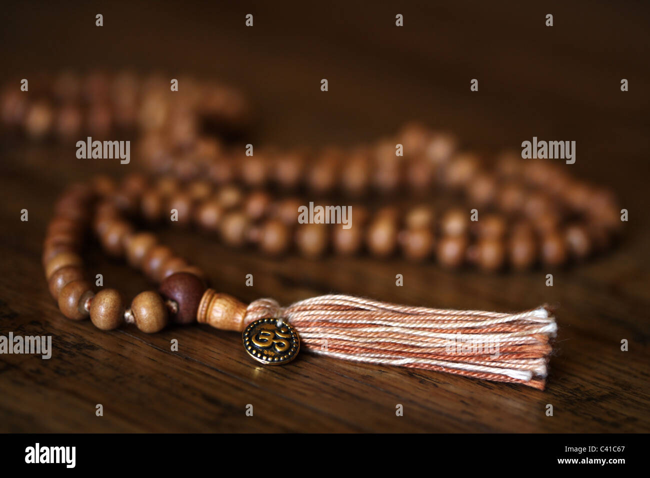 Buddhist or hindu sandalwood mala on an oak table Stock Photo - Alamy