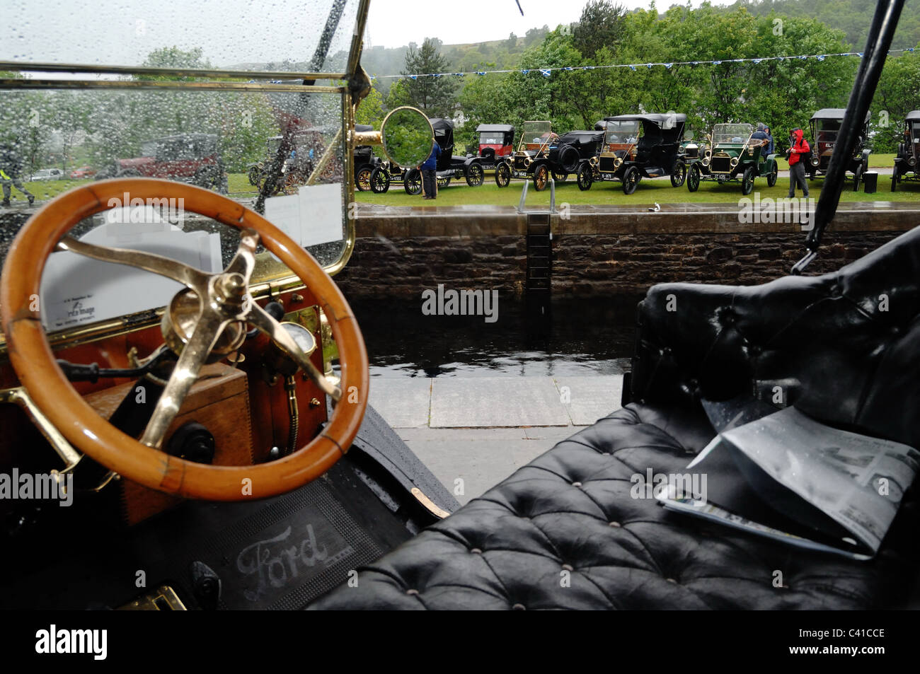 A line of model T Fords sitting on the Caledonian canal for photo shoot ...