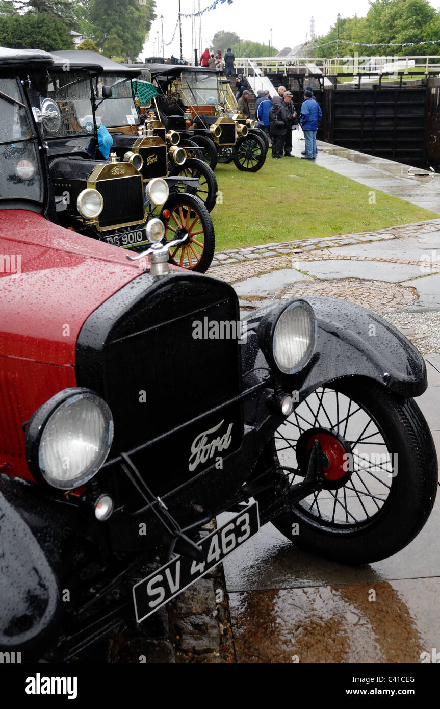 A line of model T Fords sitting on the Caledonian canal for photo shoot ...