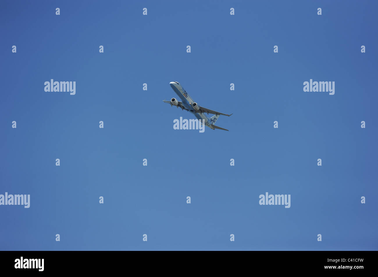 A Flybe jet plane against a clear blue sky Stock Photo - Alamy