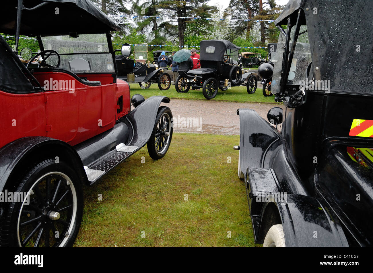 A line of model T Fords sitting on the Caledonian canal for photo shoot ...