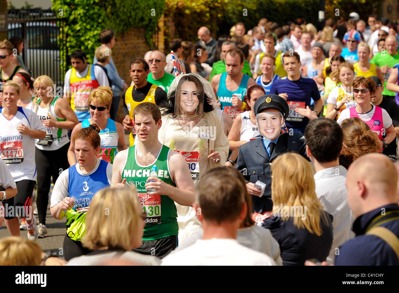 Runners take part in the Virgin 2011 London Marathon with runners ...