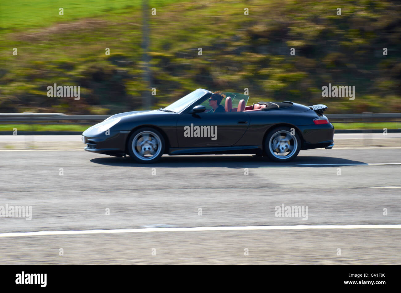 Open top Porsche sports car on the motorway Stock Photo - Alamy