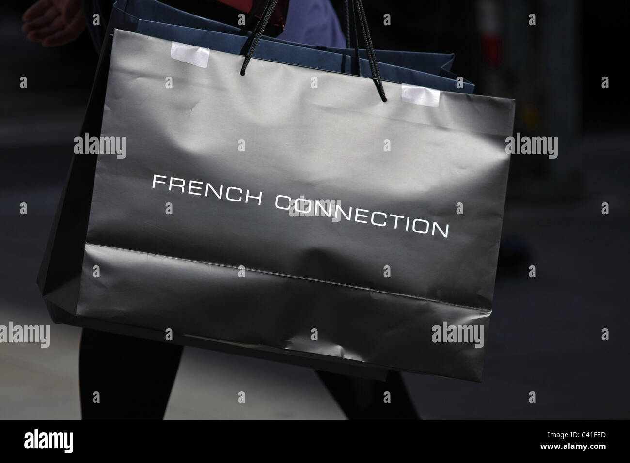 A French Connection shopping bag being carried by a lady walking in ...
