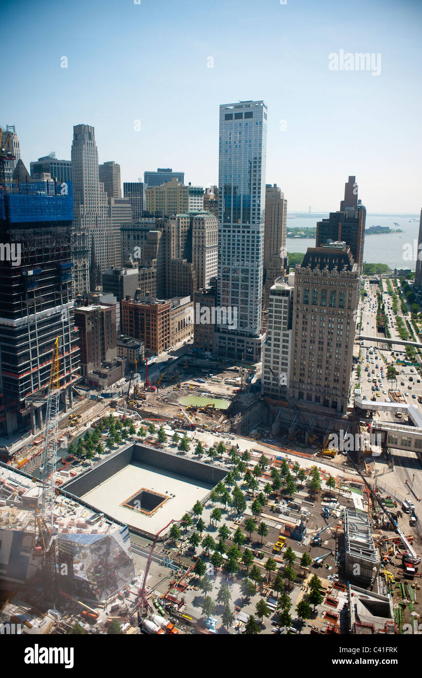 The under construction 9/11 Memorial and Museum with their reflecting ...