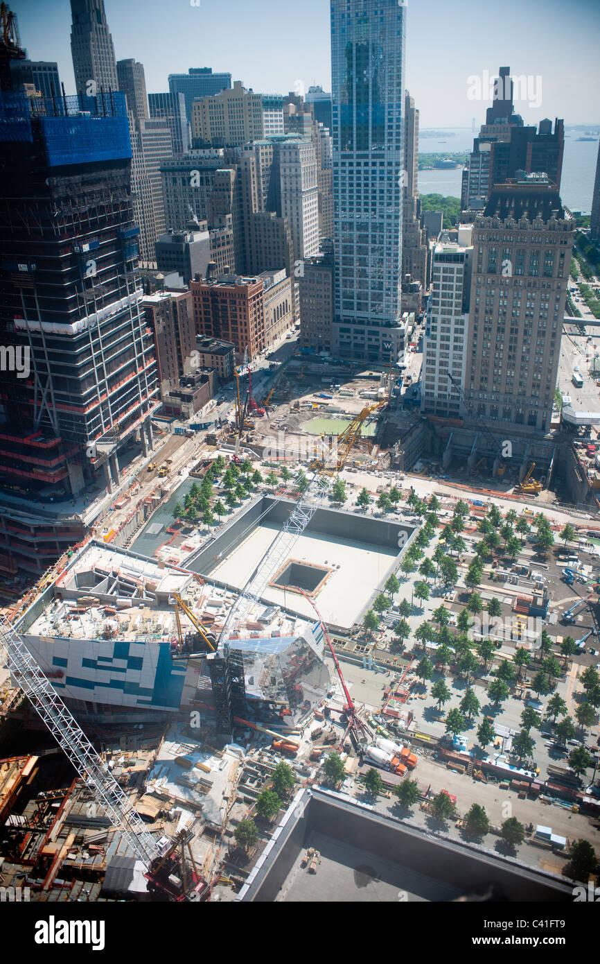 The under construction 9/11 Memorial and Museum with their reflecting ...