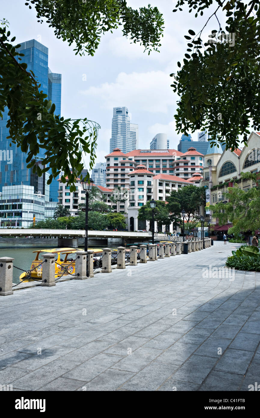 Swissotel Merchant Court with The City Skyscrapers Behind and Boats on ...