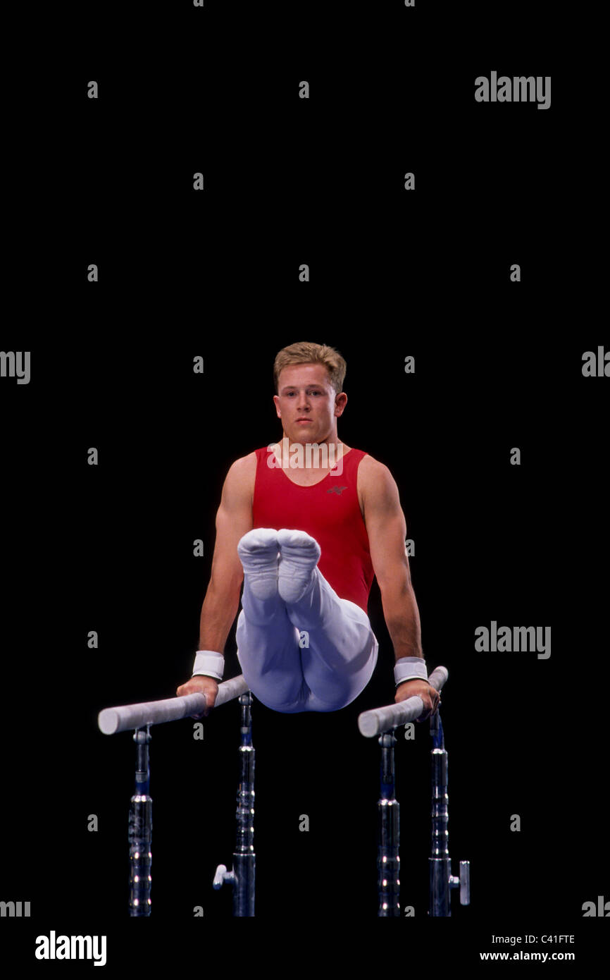 Male gymnast on the parallel bars Stock Photo - Alamy
