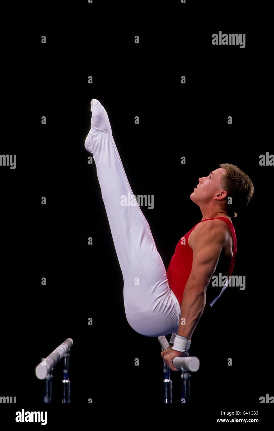 Male gymnast on the parallel bars Stock Photo - Alamy