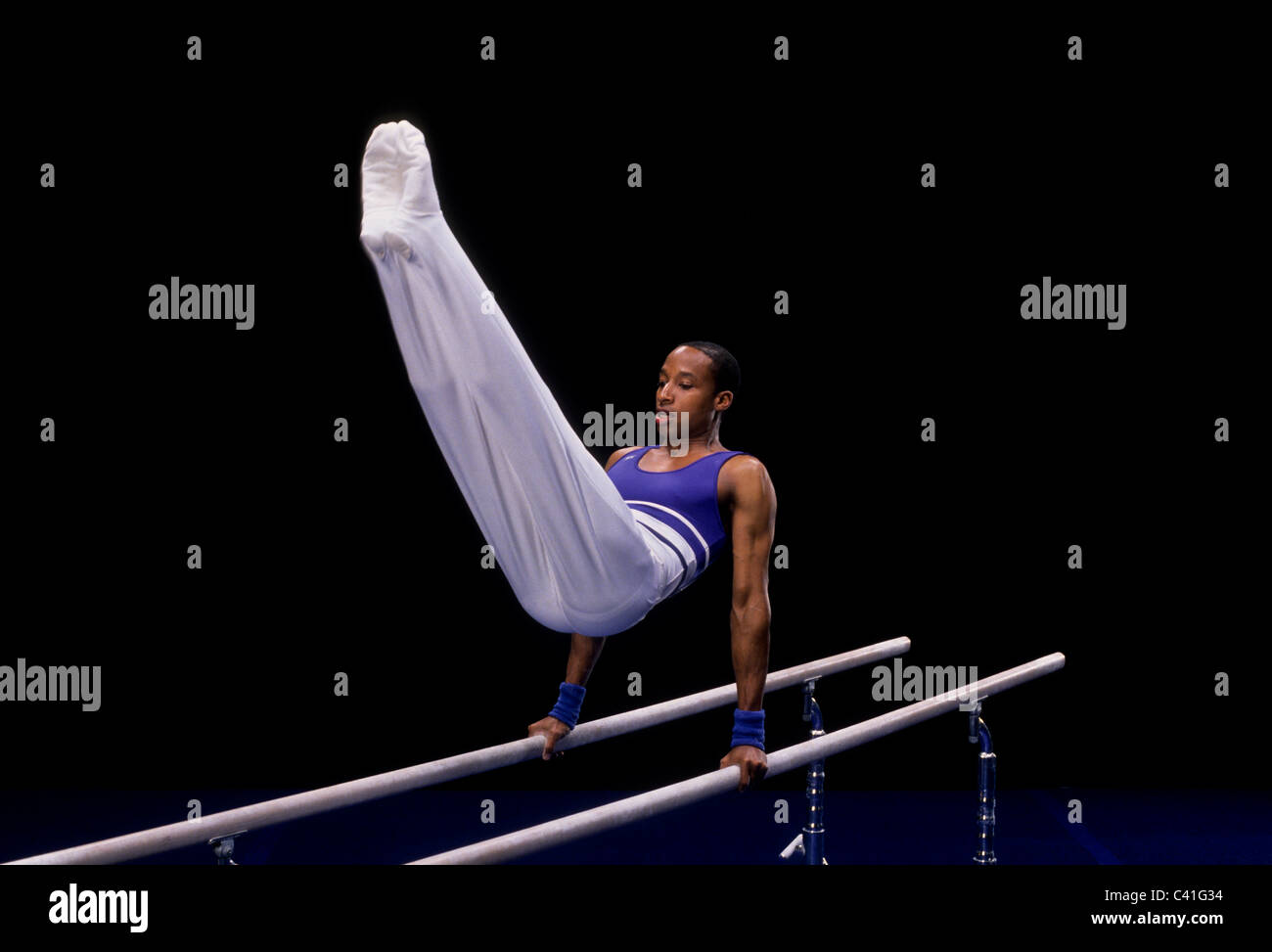 Male gymnast on the parallel bars Stock Photo - Alamy