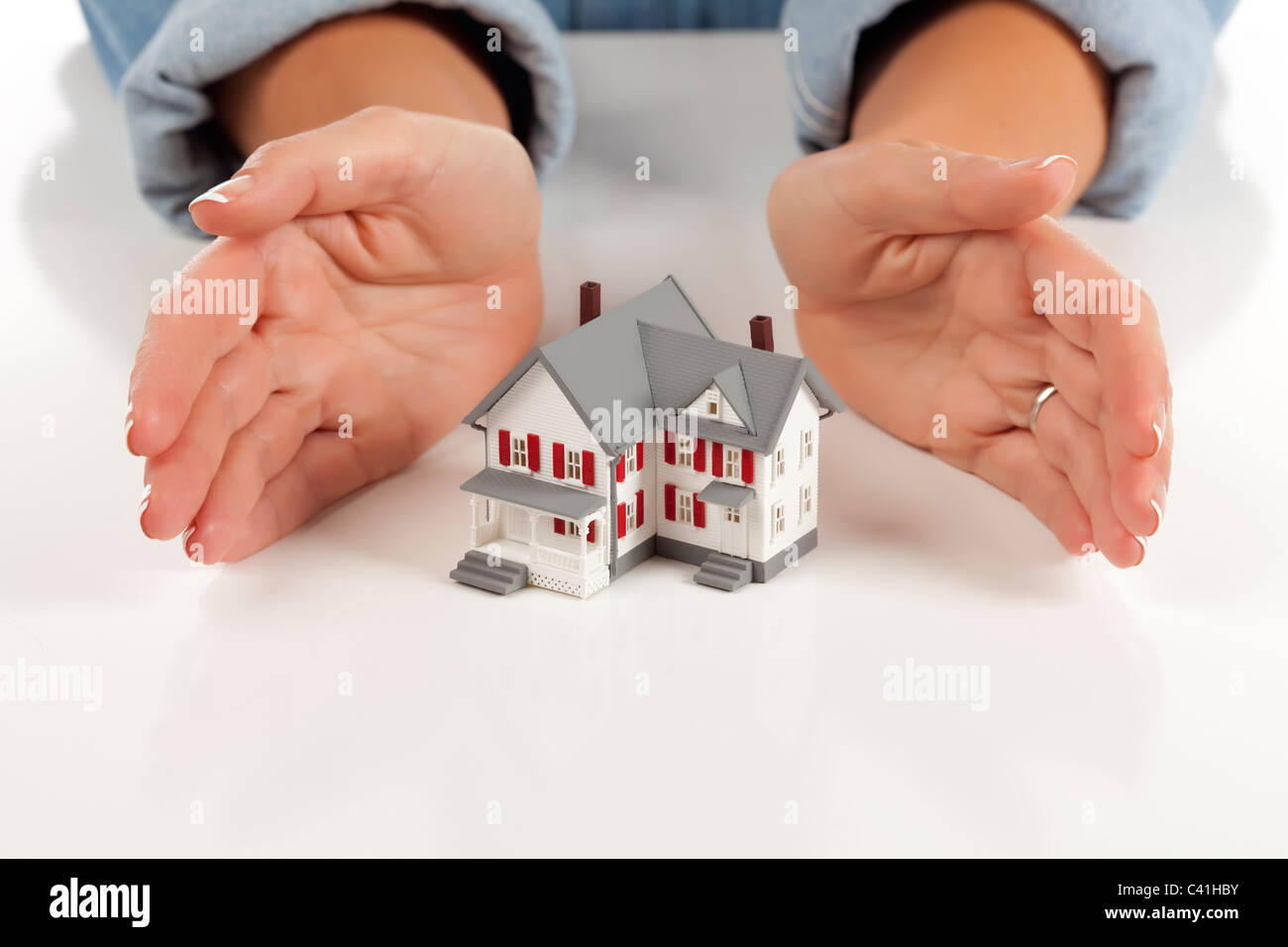 Womans Hands Around Model House on White Surface Stock Photo - Alamy