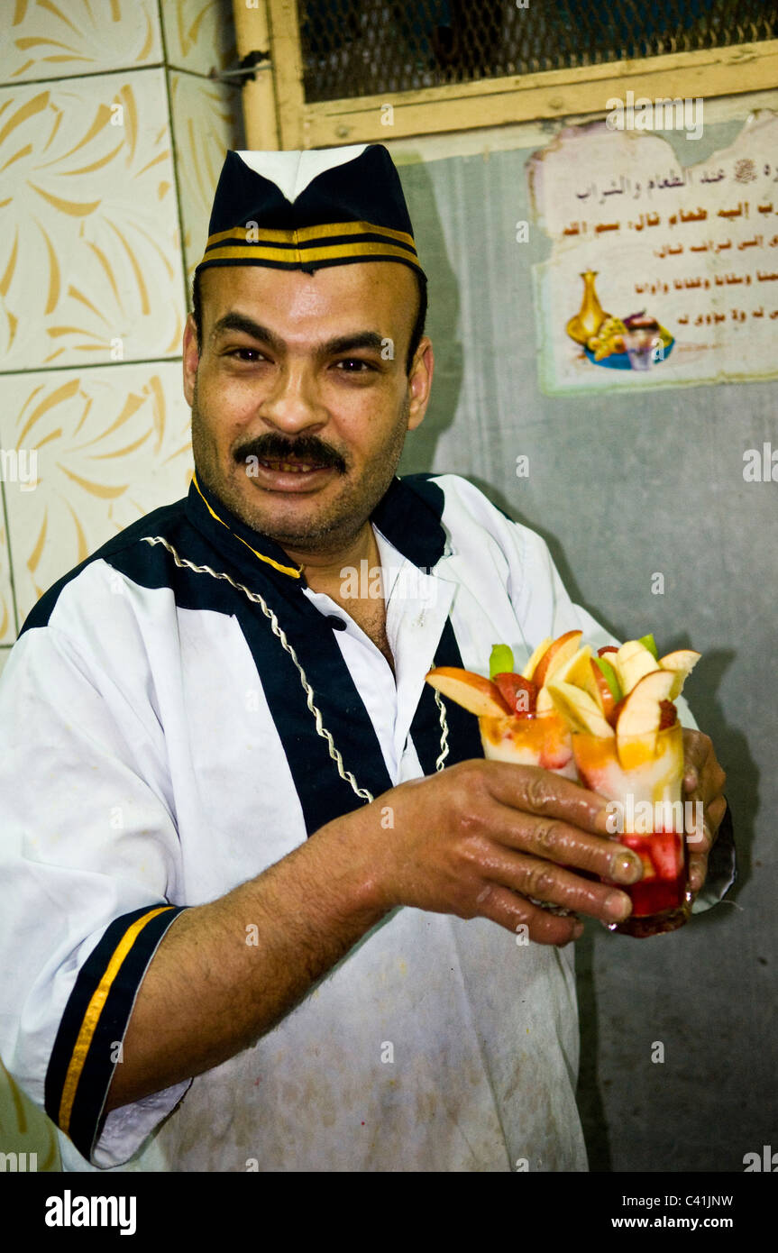 A colorful waiter at a fruit & ice cream shop in Cairo Stock Photo - Alamy