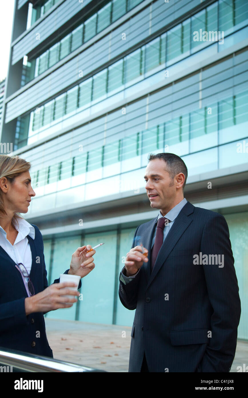 Colleagues taking smoke break outdoors Stock Photo - Alamy