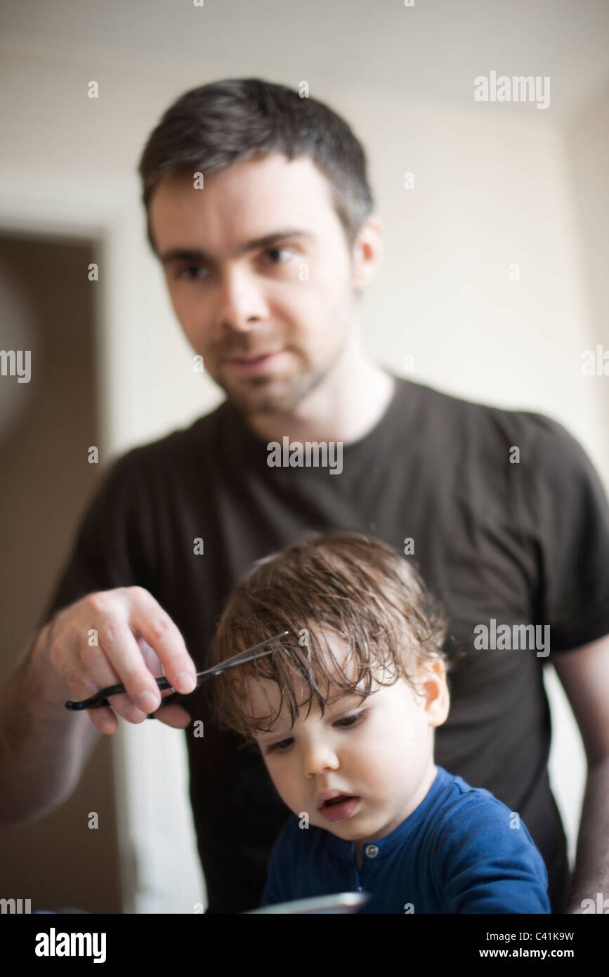 Father cutting toddler son's hair Stock Photo - Alamy