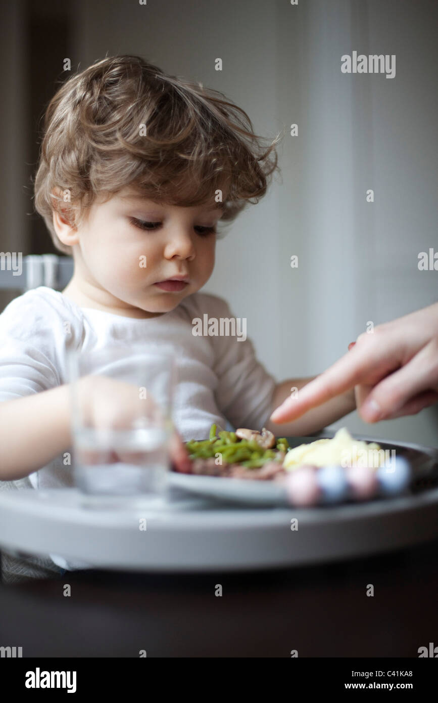 Toddler boy being told to eat his vegetables, cropped Stock Photo - Alamy
