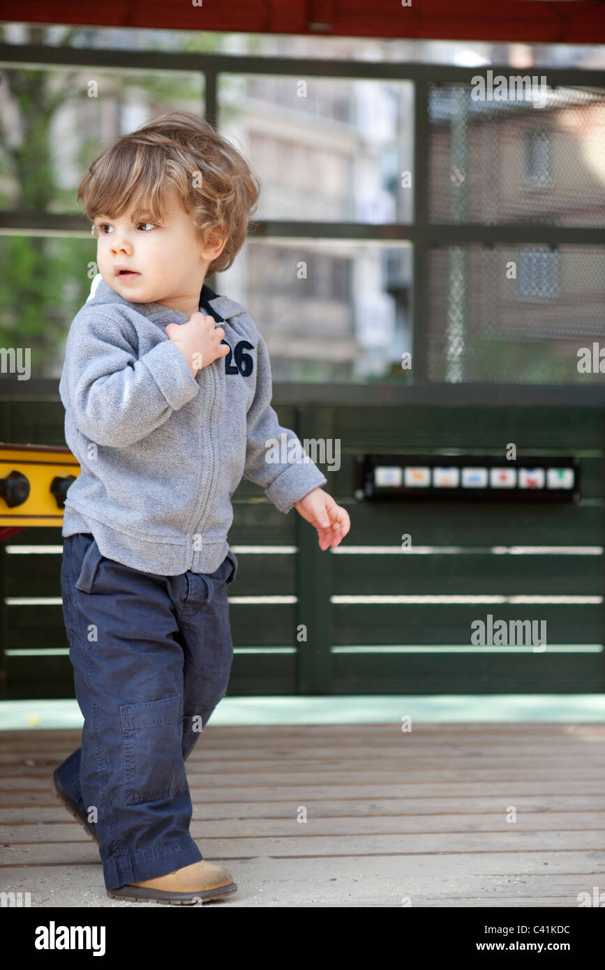 Little boy walking on playground Stock Photo - Alamy