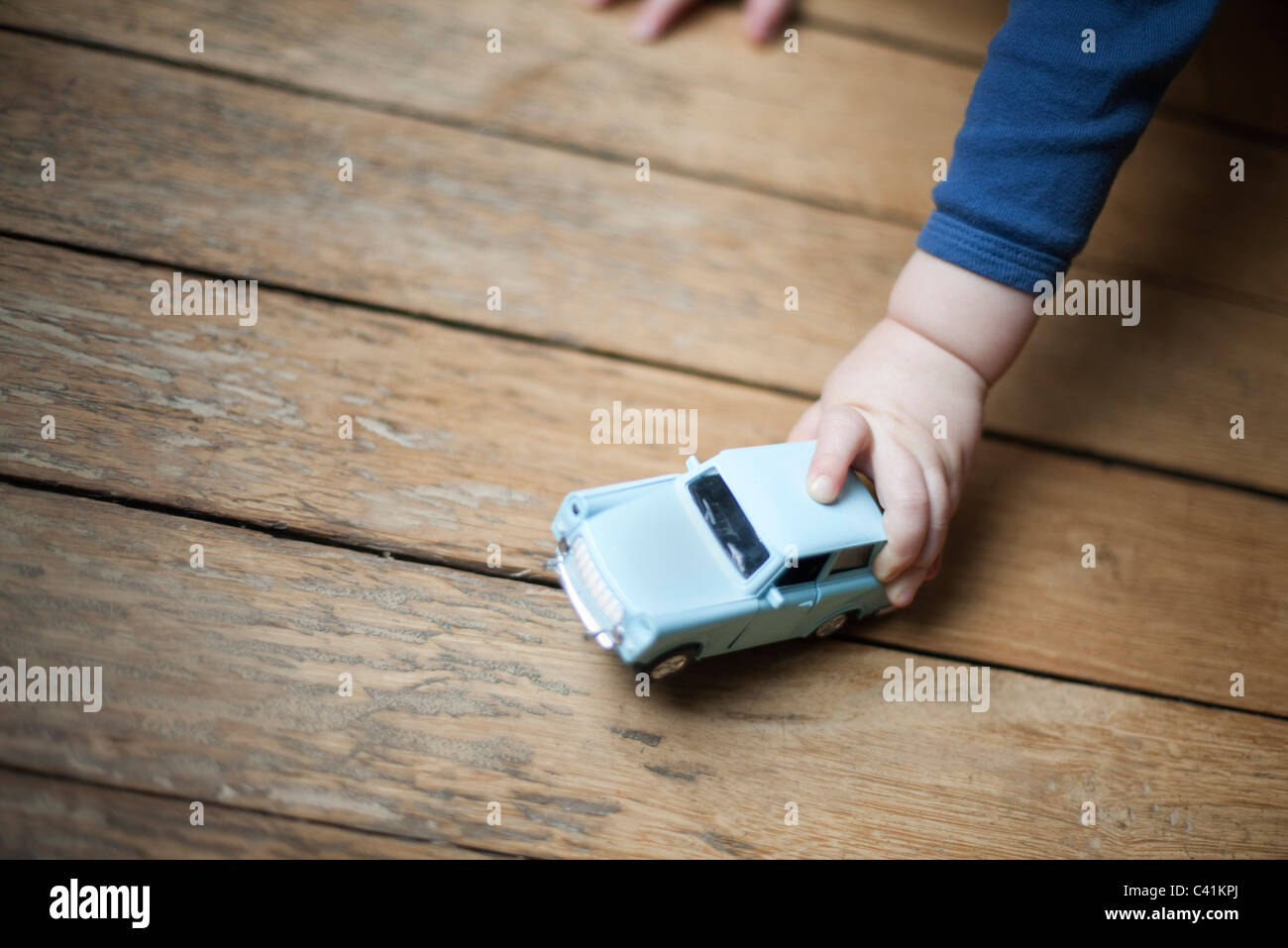 Child's hand holding toy car Stock Photo - Alamy