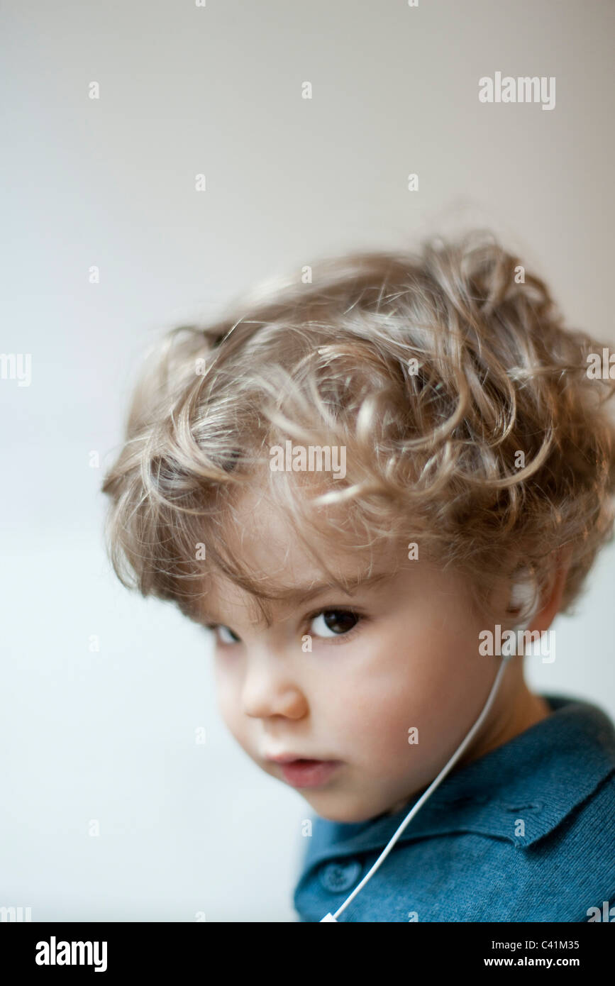 Toddler boy wearing earphones, portrait Stock Photo - Alamy