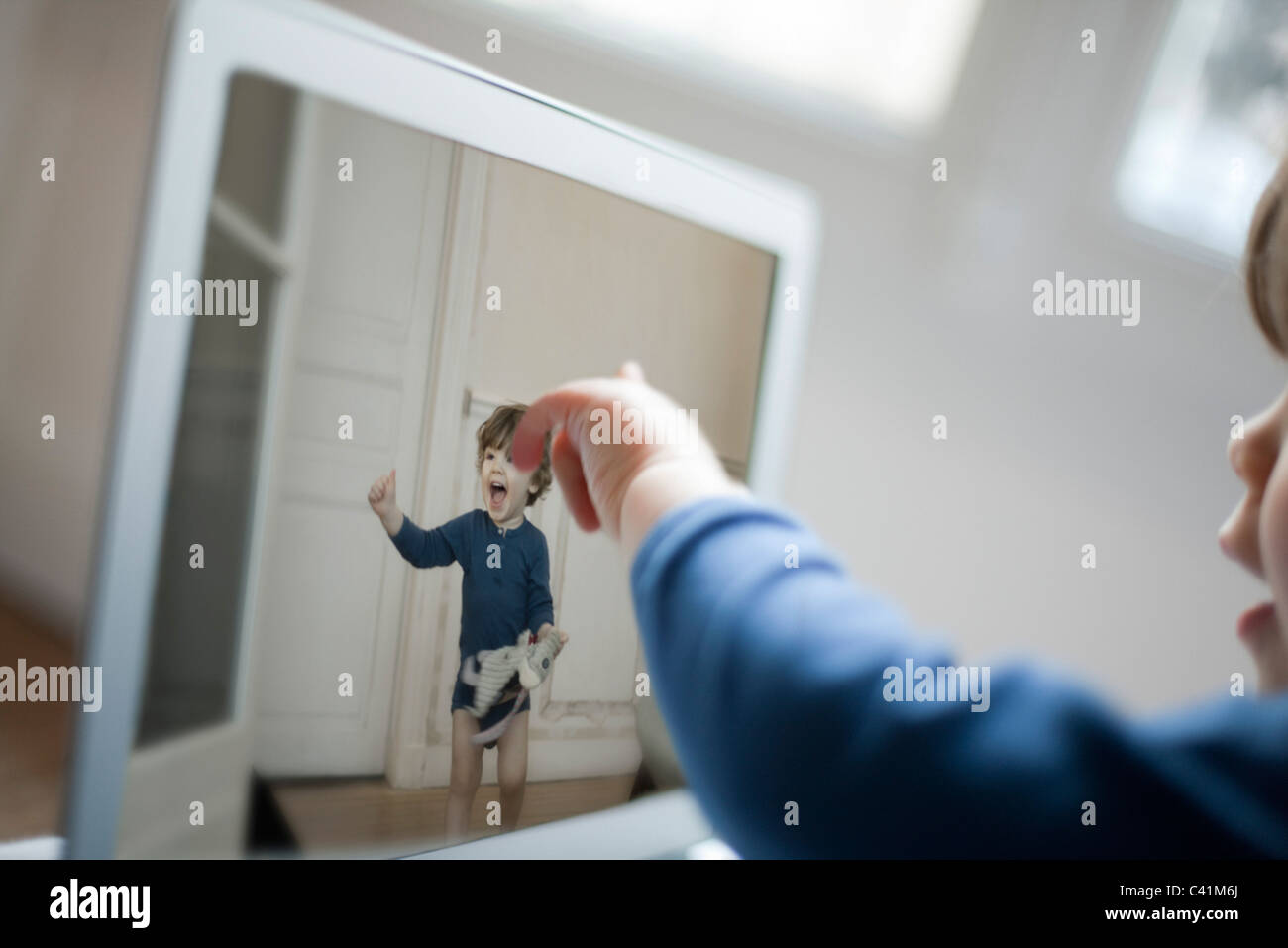 Toddler pointing at laptop screen Stock Photo - Alamy