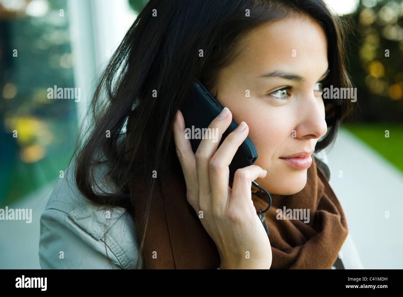 Young woman using cell phone, portrait Stock Photo - Alamy