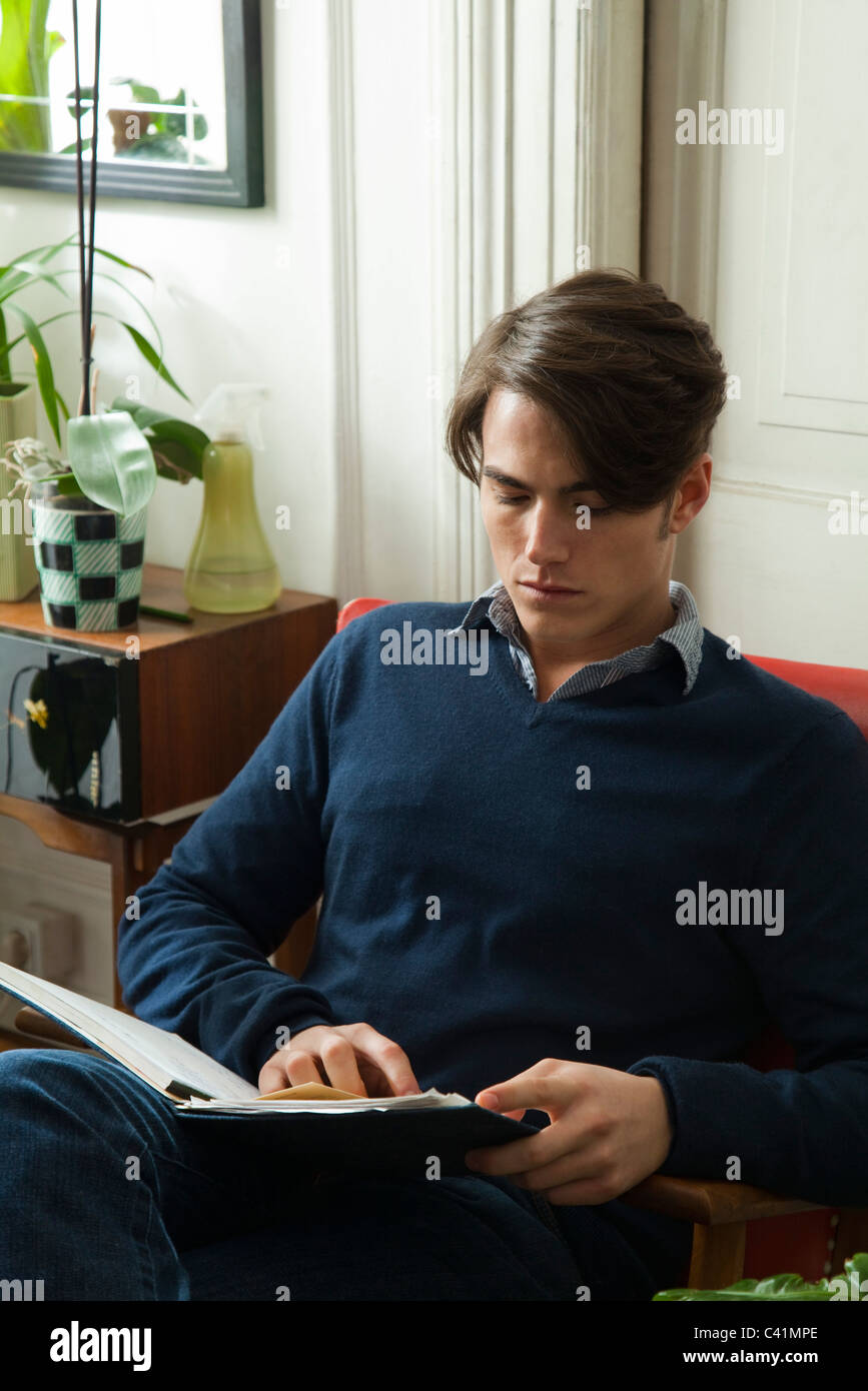 Man reading book at home Stock Photo - Alamy