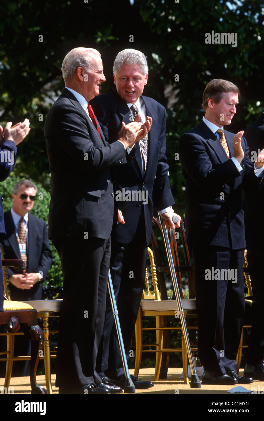 President Bill Clinton on crutches with James Baker at the White House ...