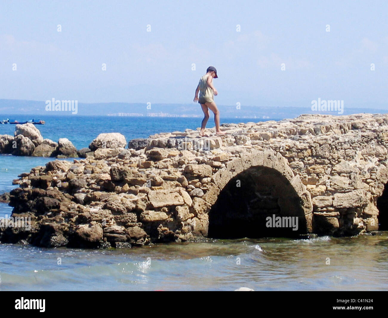 Holiday makers sunbathing on the small beach in Argassi Greece Stock ...