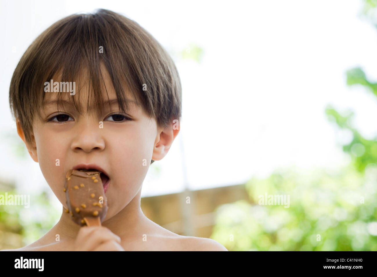 Little boy eating ice cream bar, portrait Stock Photo - Alamy
