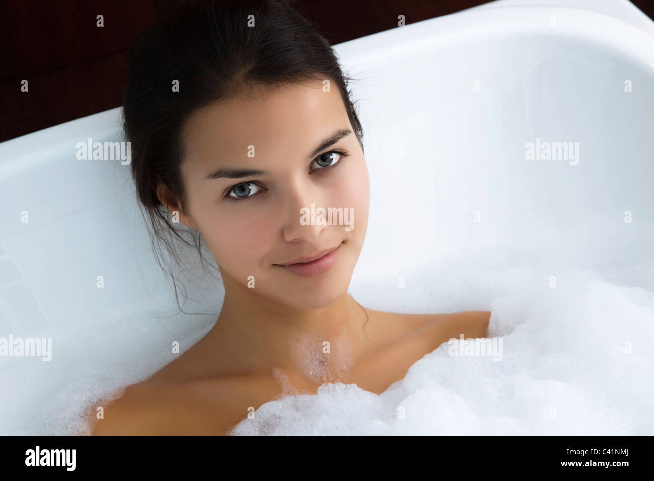 Woman relaxing in bubble bath, portrait Stock Photo - Alamy